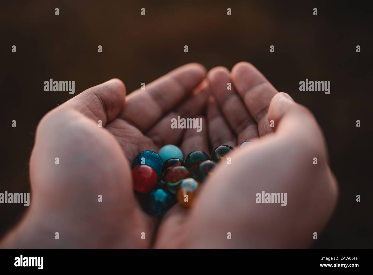Hand holding marbles hi-res stock photography and images - Alamy