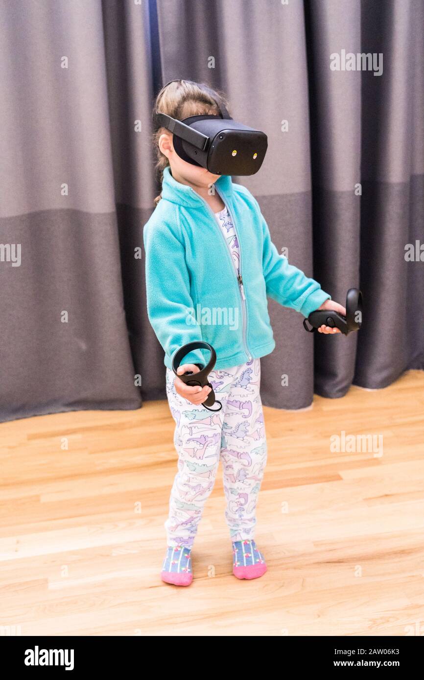Little girl playing VR kids game in the living room Stock Photo - Alamy