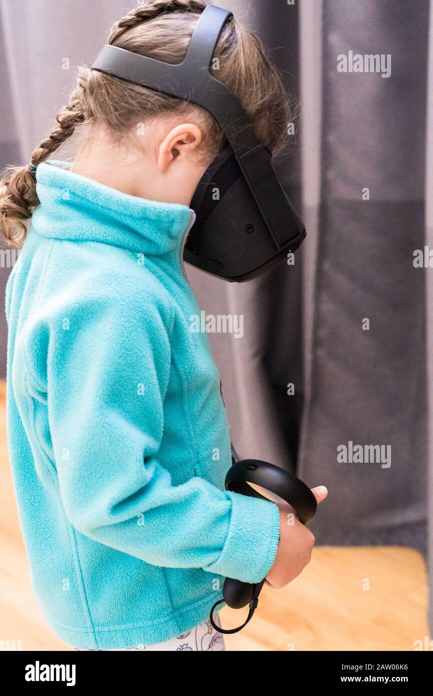 Little girl playing VR kids game in the living room Stock Photo - Alamy
