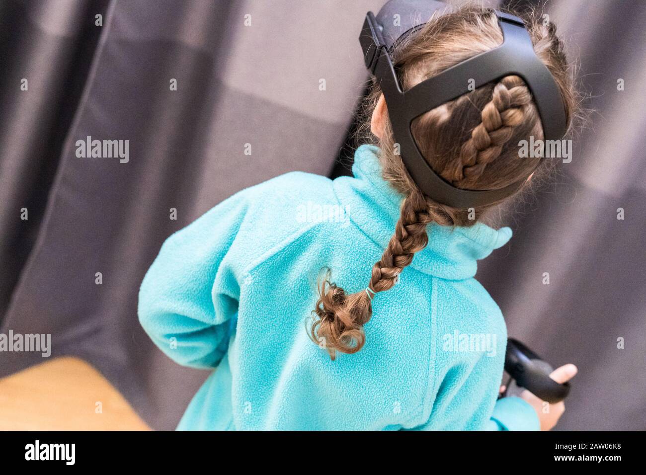 Little girl playing VR kids game in the living room Stock Photo - Alamy