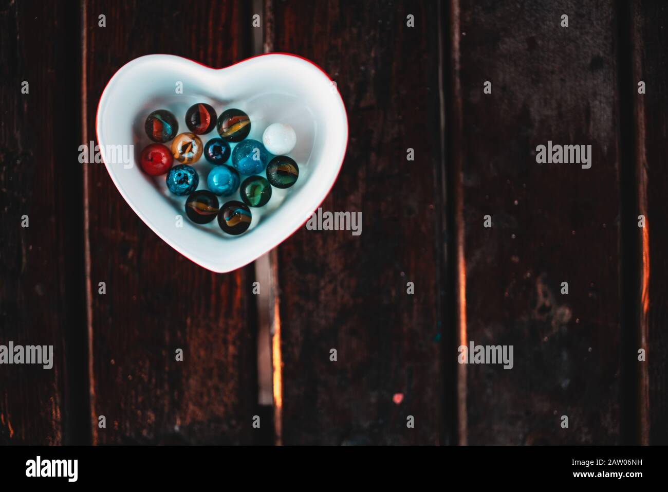 Heart shaped marble bowl on the table, marble balls inside. Background ...