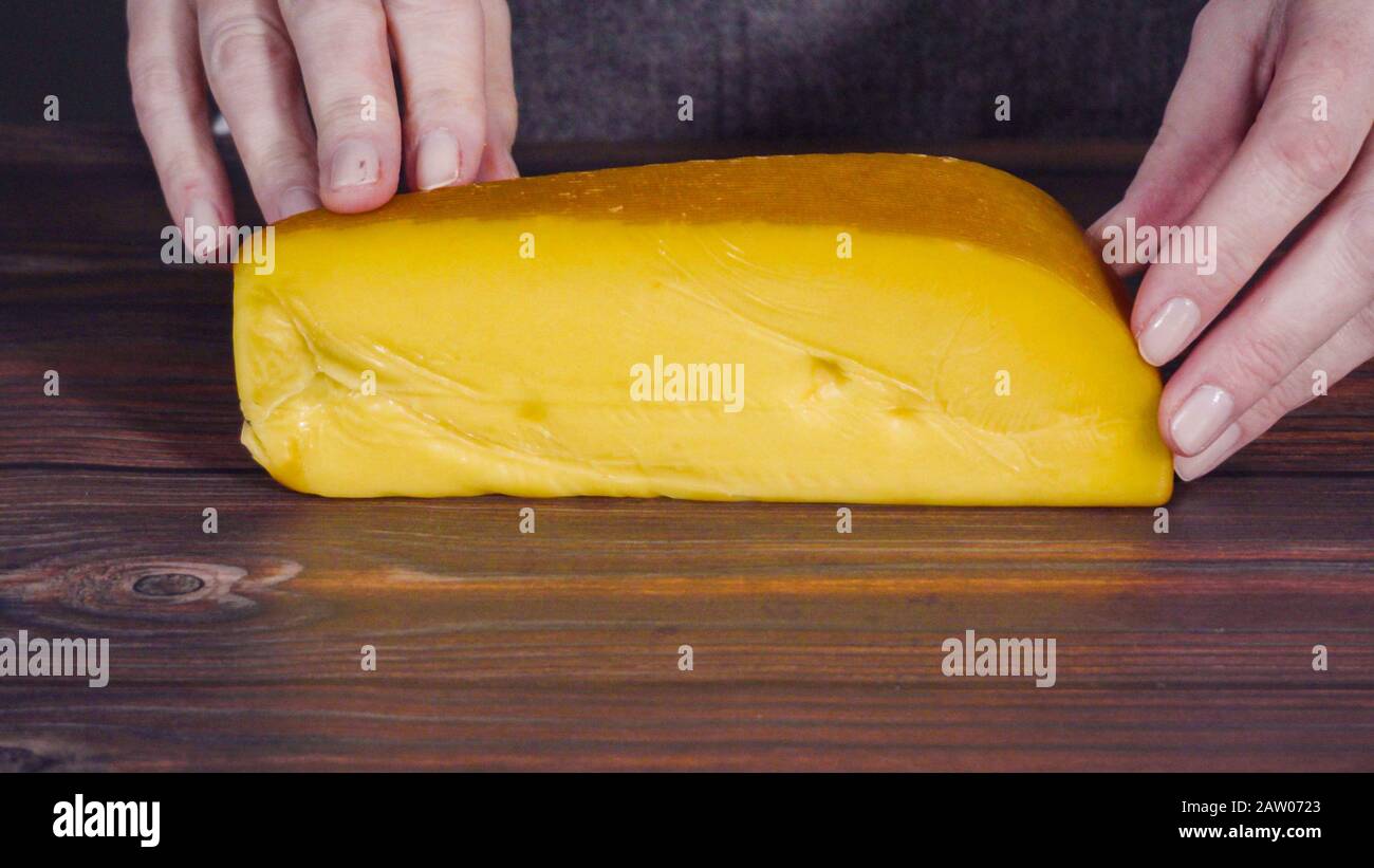 Large wedge of smoked gouda cheese on a rustic wood background Stock ...