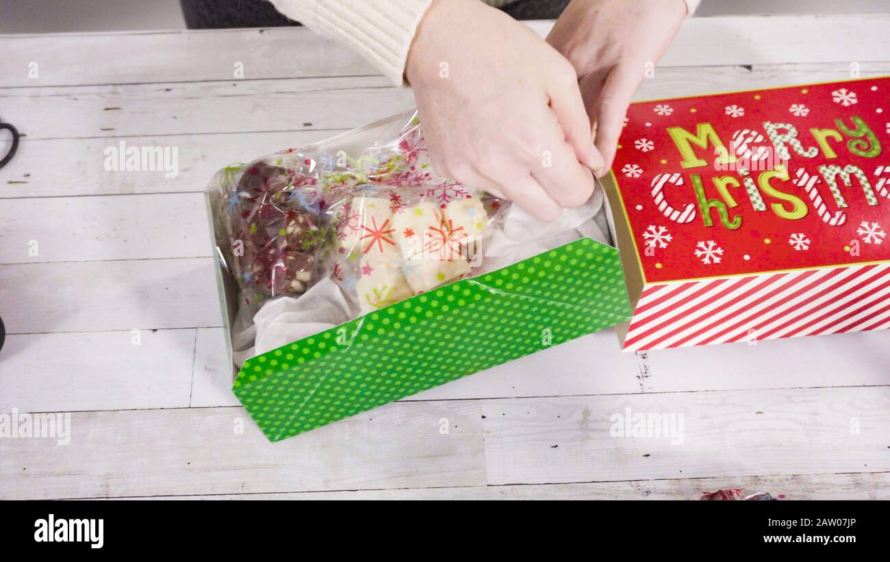 Step by step. Packaging homemade fudge and cookies into a Christmas ...