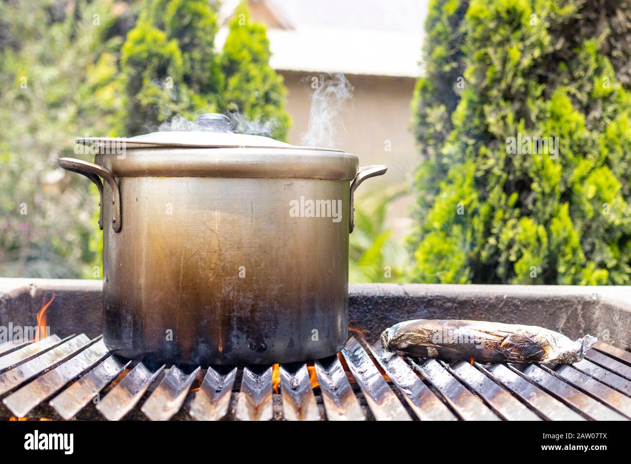 Preparation of soup in a pot, in nature. Cooking soup through the wood ...