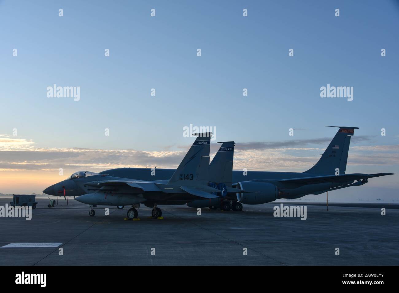 An F-15 Eagle from the 125th Fighter Wing rests on the ramp next to a ...