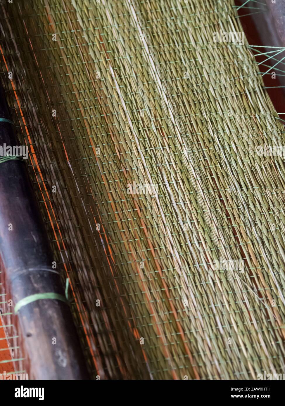 Traditional weaving of mats from a reed growing along the Mekong River ...