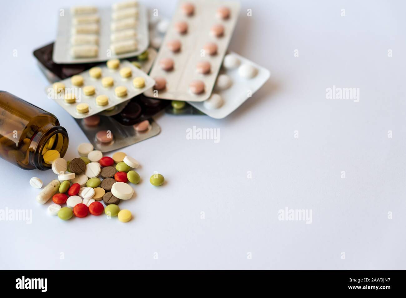 Medicine and pills. Multi-colored medicines on a white background close ...