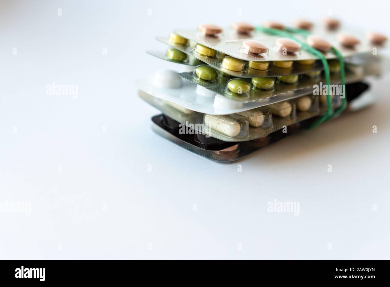 Medicine and pills. Multi-colored medicines on a white background close ...