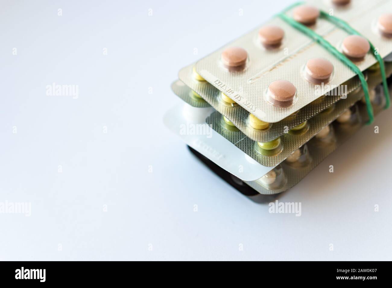 Medicine and pills. Multi-colored medicines on a white background close ...