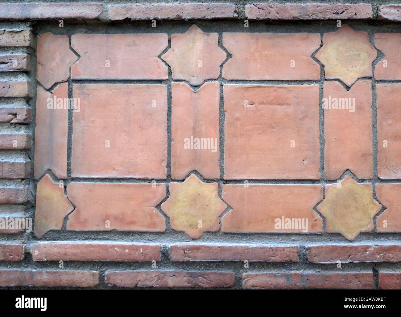 Closeup of decorative Tiles recessed in brick wall Stock Photo - Alamy