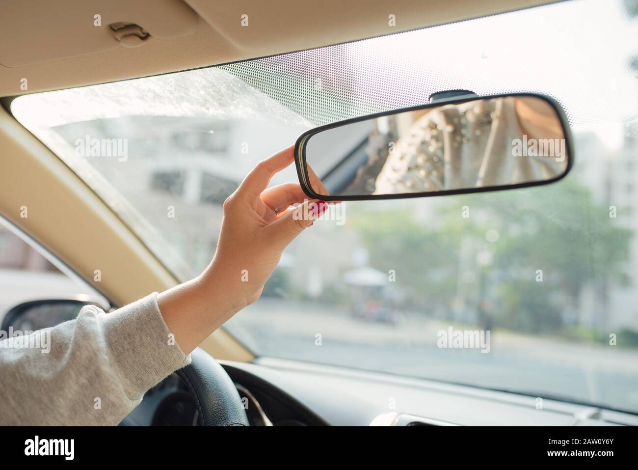Woman hands adjusting rear view mirror in the car Stock Photo - Alamy