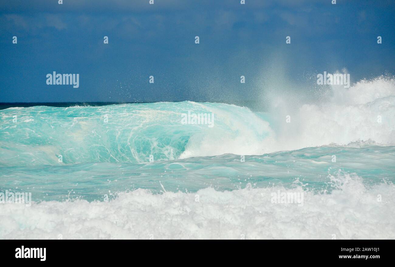 Surfers riding world-renowned crashing waves in Banzai Pipeline on ...