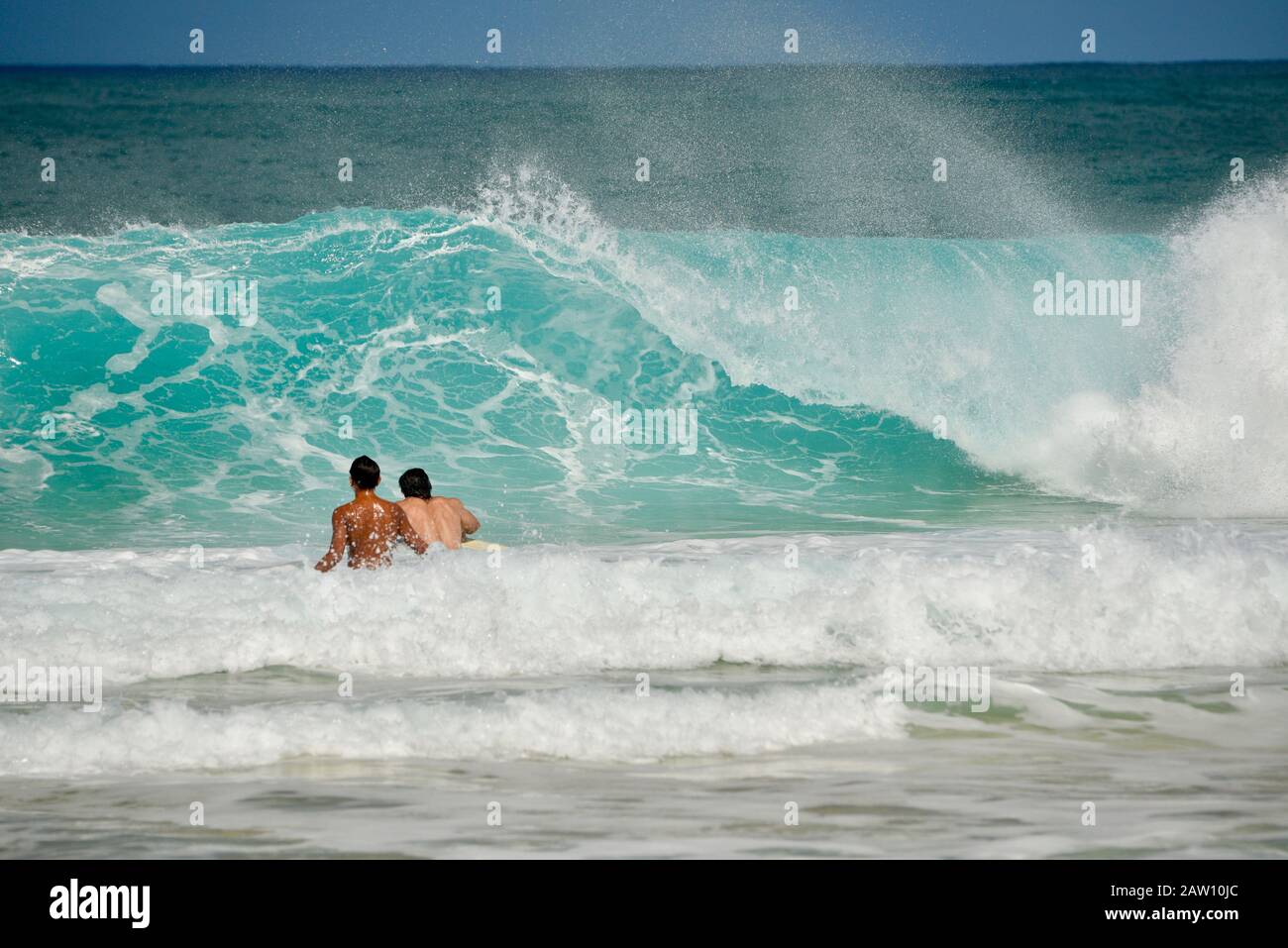 Surfers padding out to world-renowned crashing, barreling curved ...