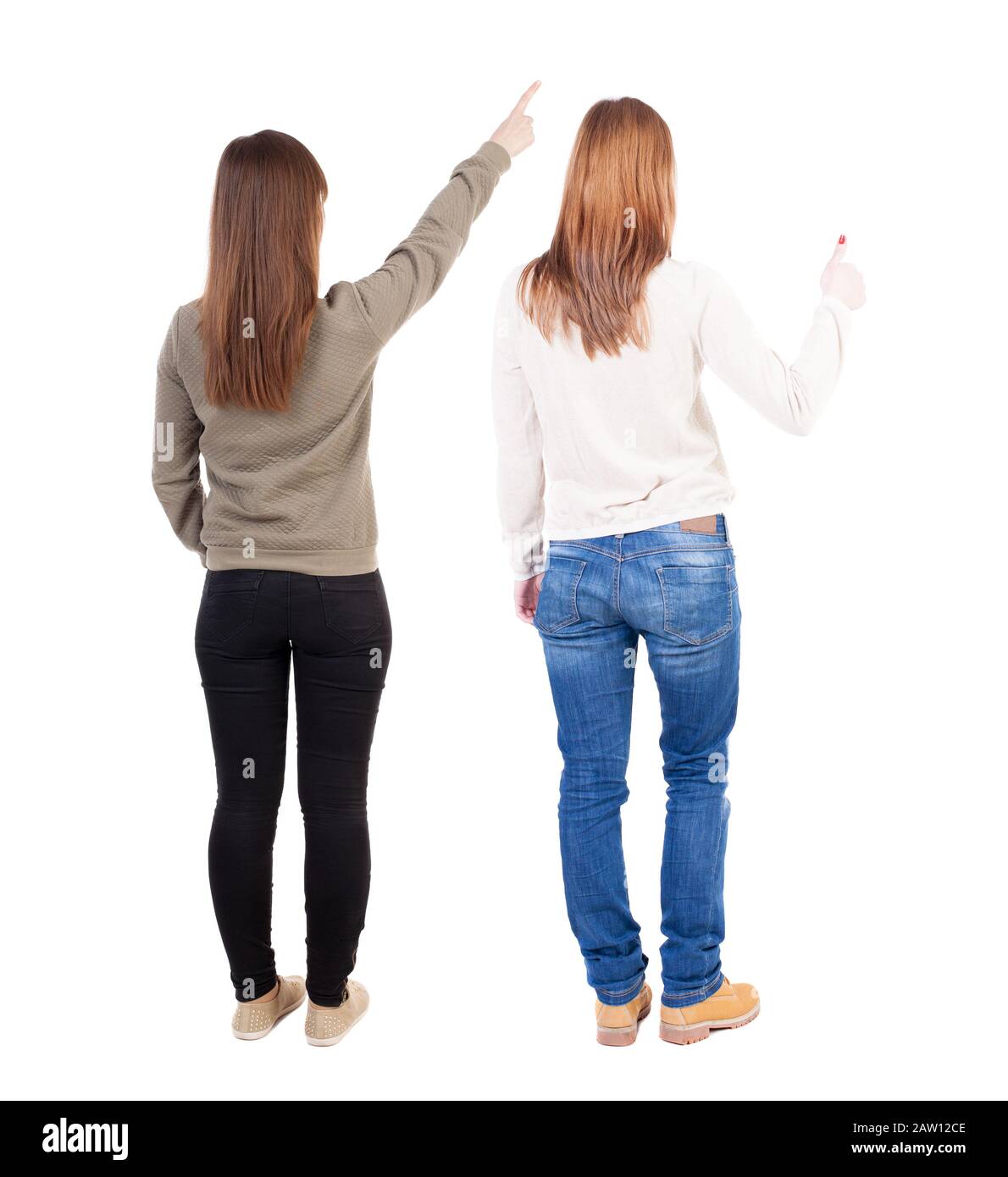 Back view of two pointing young girl in sweater. Rear view people ...