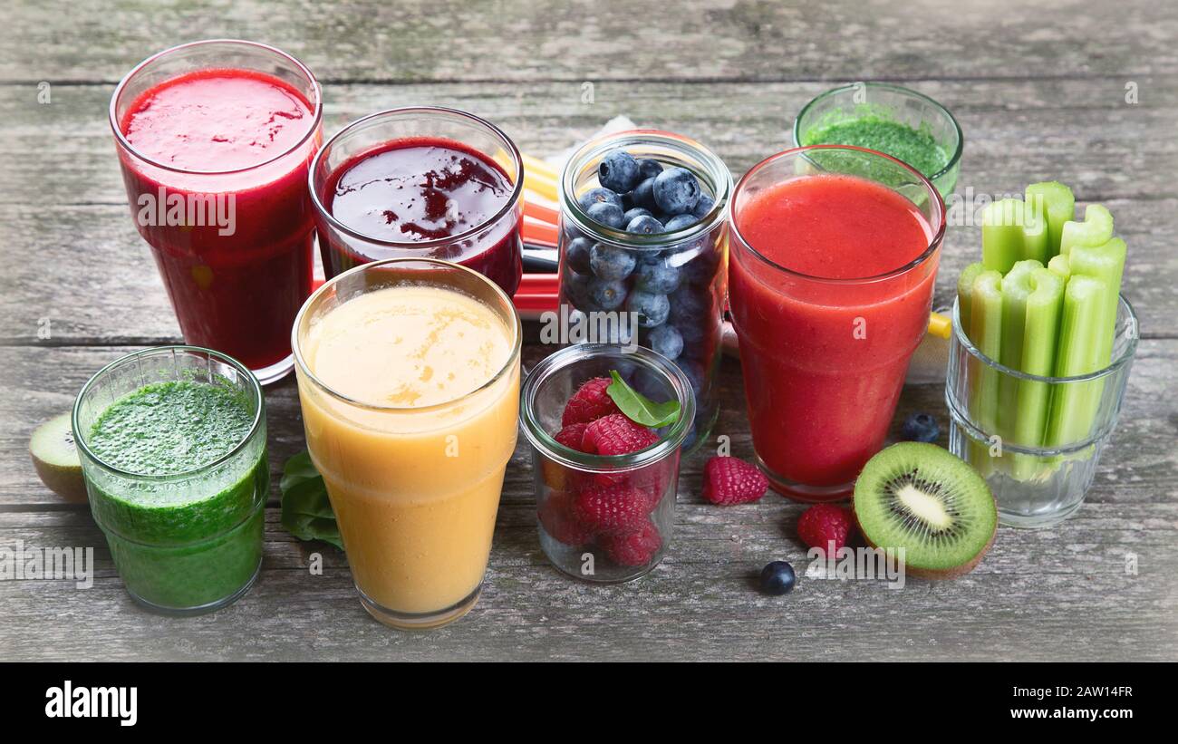 Different types of smoothies on wooden background. Healthy clean and ...