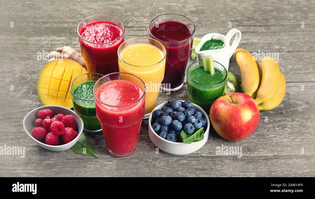 Different types of smoothies on wooden background. Healthy clean and ...