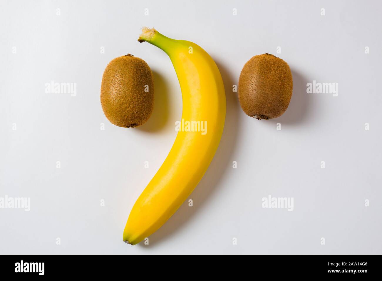 Banana with two kiwis on a white background. Fresh fruit, healthy and ...