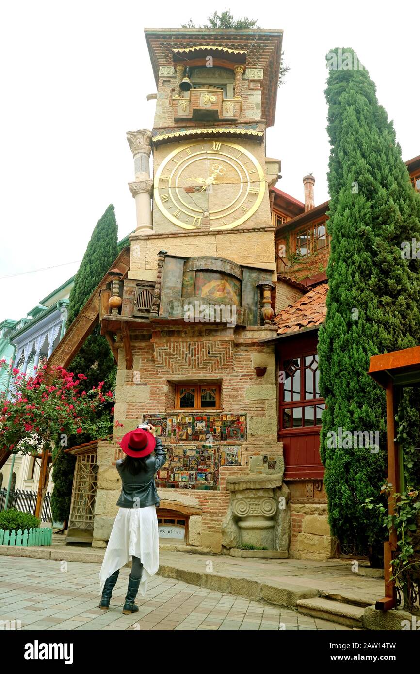 Female Traveler Taking Photos of the Leaning Clock Tower Created by the ...