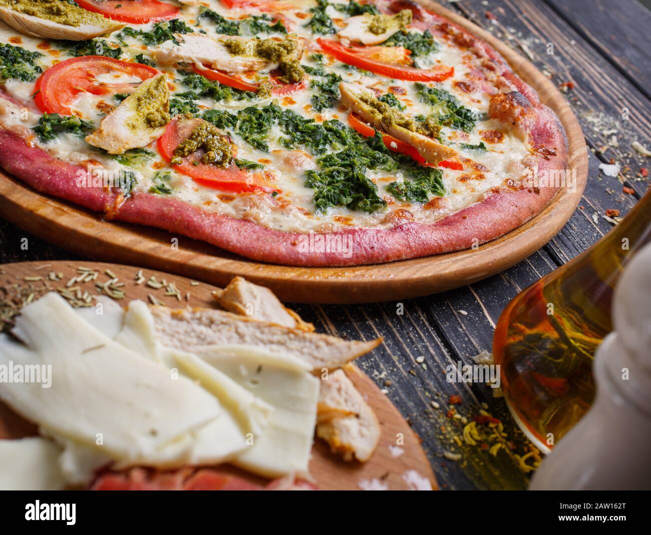 Traditional Italian pizza on a dark table with ingredients Stock Photo ...