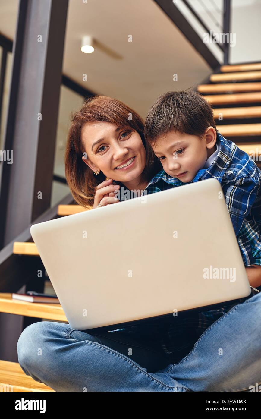 Mom and son are doing homework on the computer. Concept mom and ...