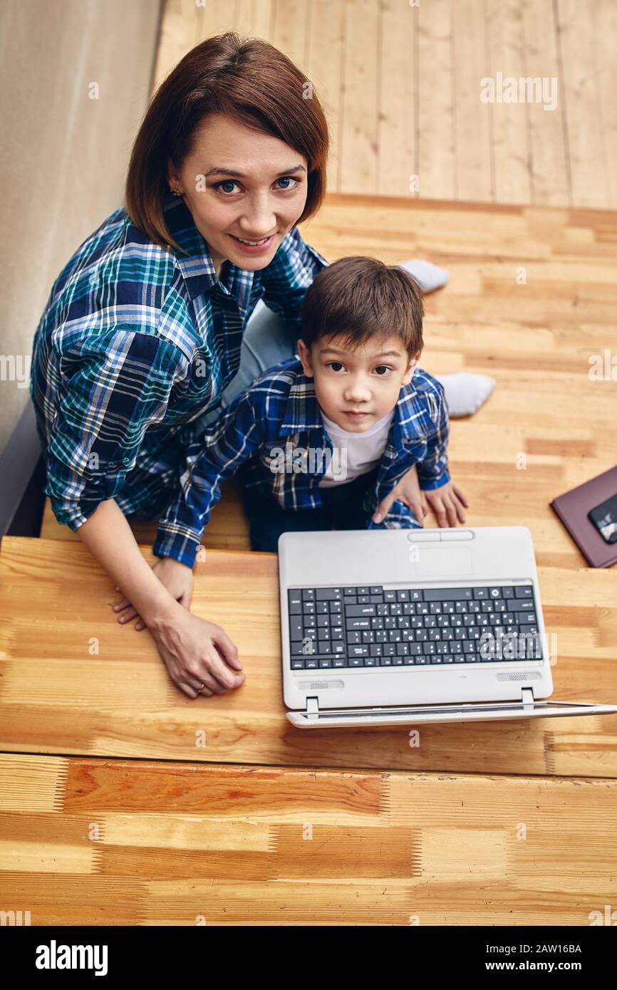 Mom and son are doing homework on the computer. Concept mom and ...