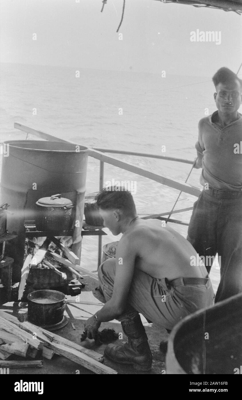 Big East [on a ship. A young man stokes a fire under a cauldron ...