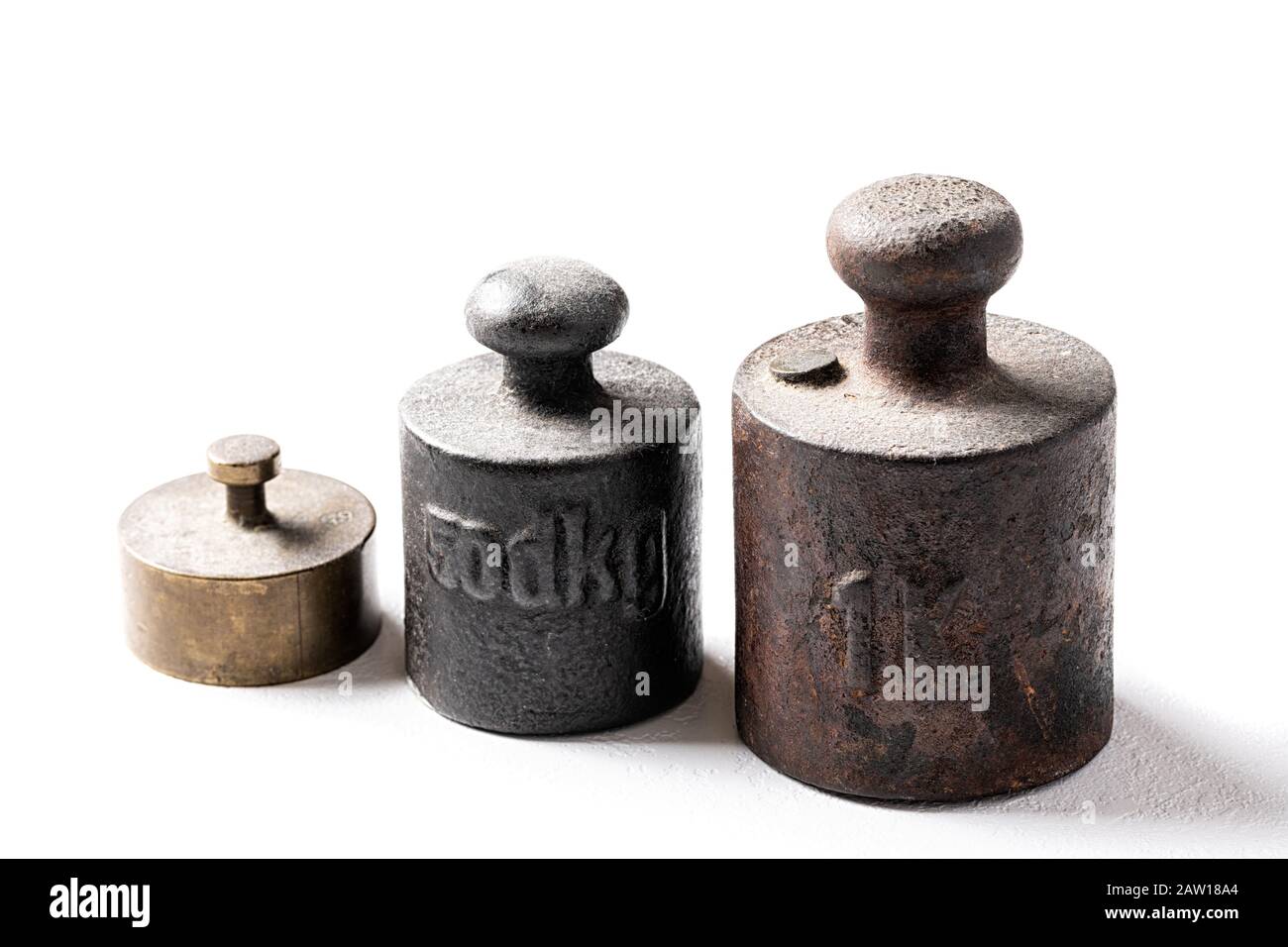 Old rustic metal weights on white background Stock Photo - Alamy