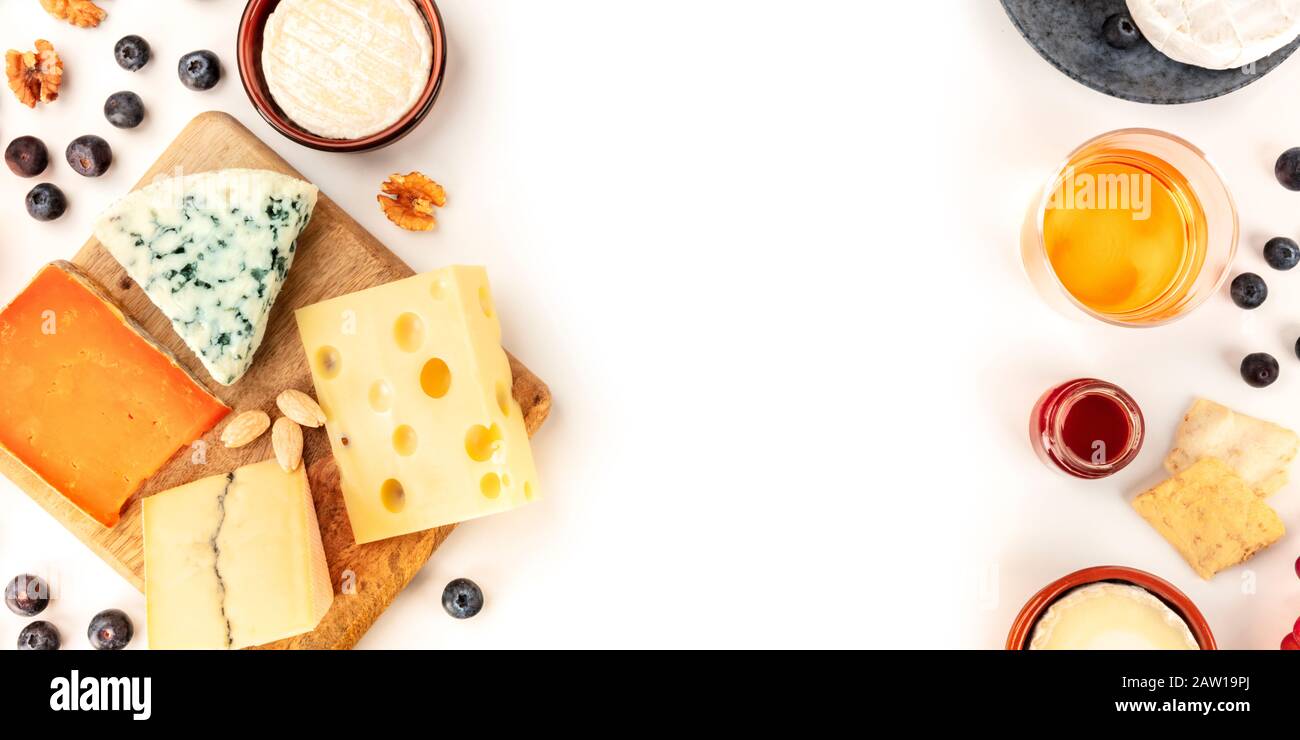 Cheese panoramic background, a top shot on white with copy space. An ...