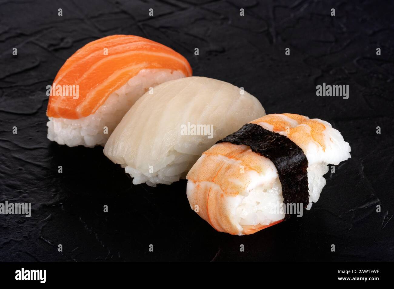 Nigiri sushi set, close-up on a black background. Fresh salmon, white ...
