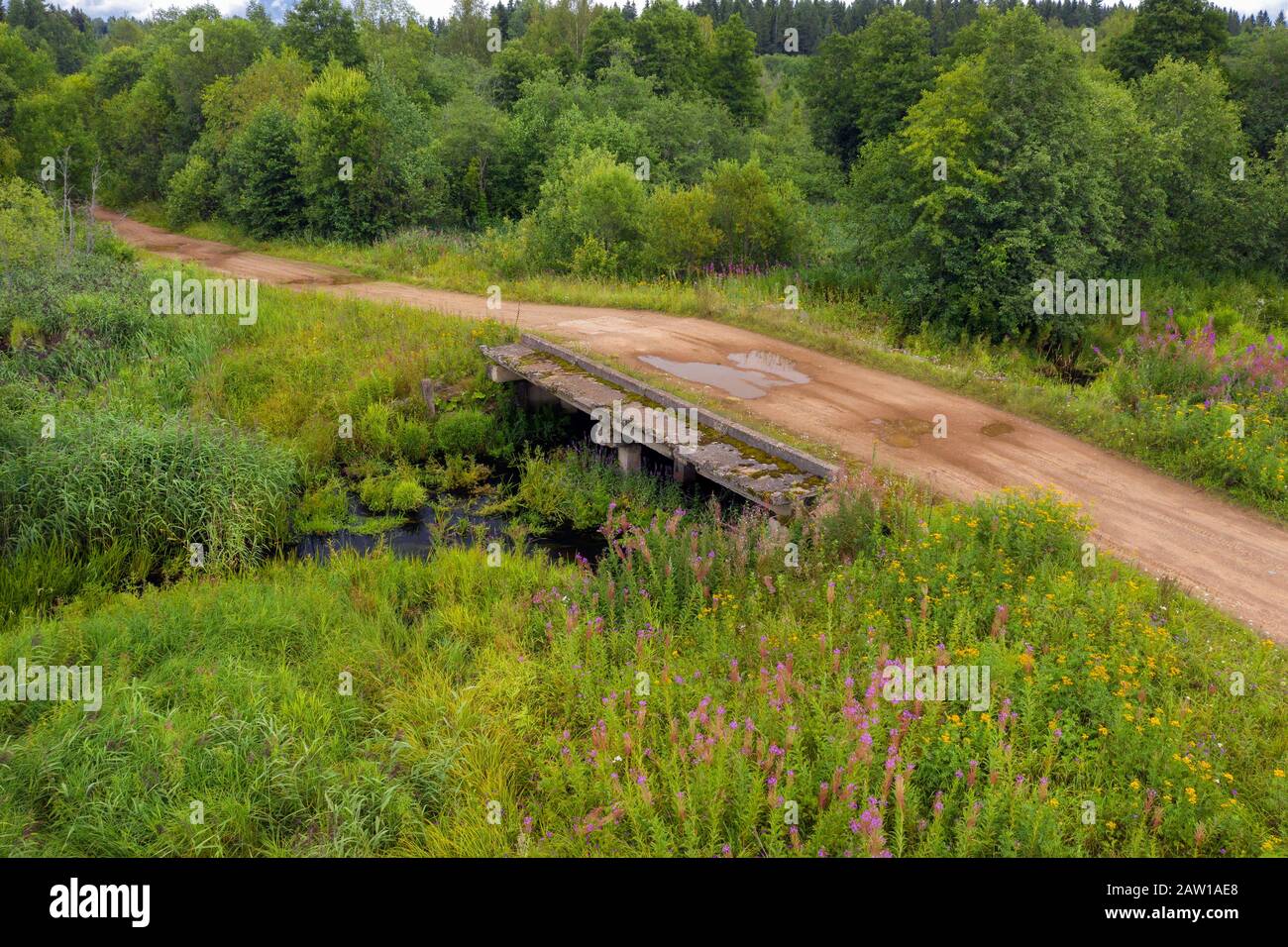 Top view of a country road and the collapsing old bridge over an ...