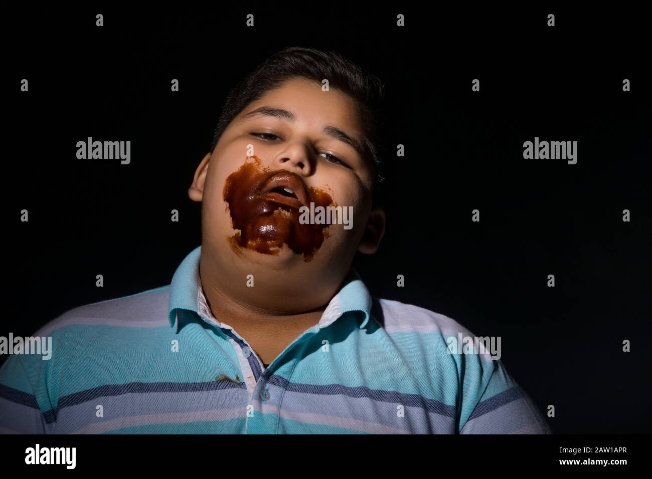 Young boy tired after having too much chocolates. (Obesity Stock Photo ...