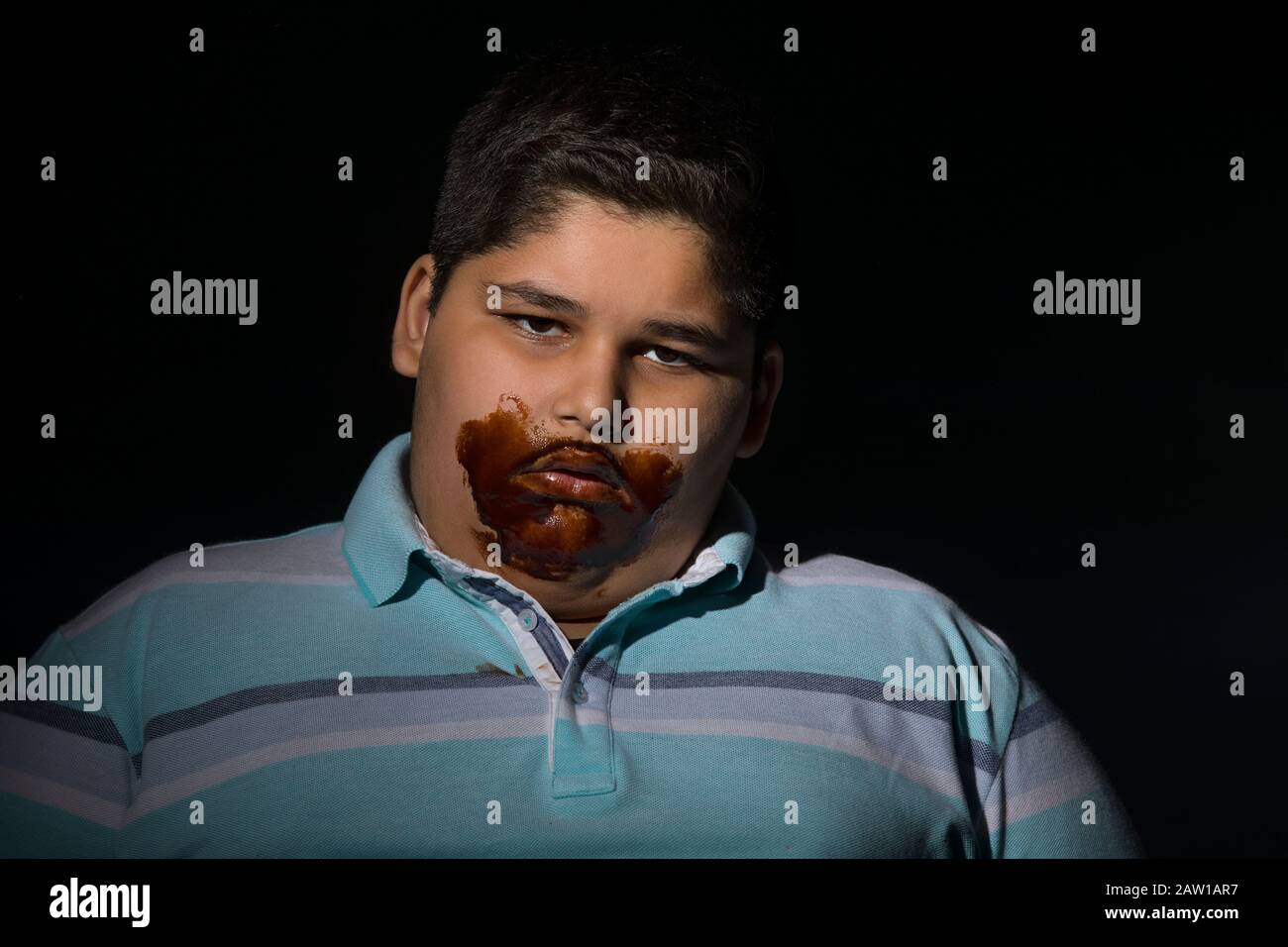 Young boy tired after having too much chocolates. (Obesity Stock Photo ...