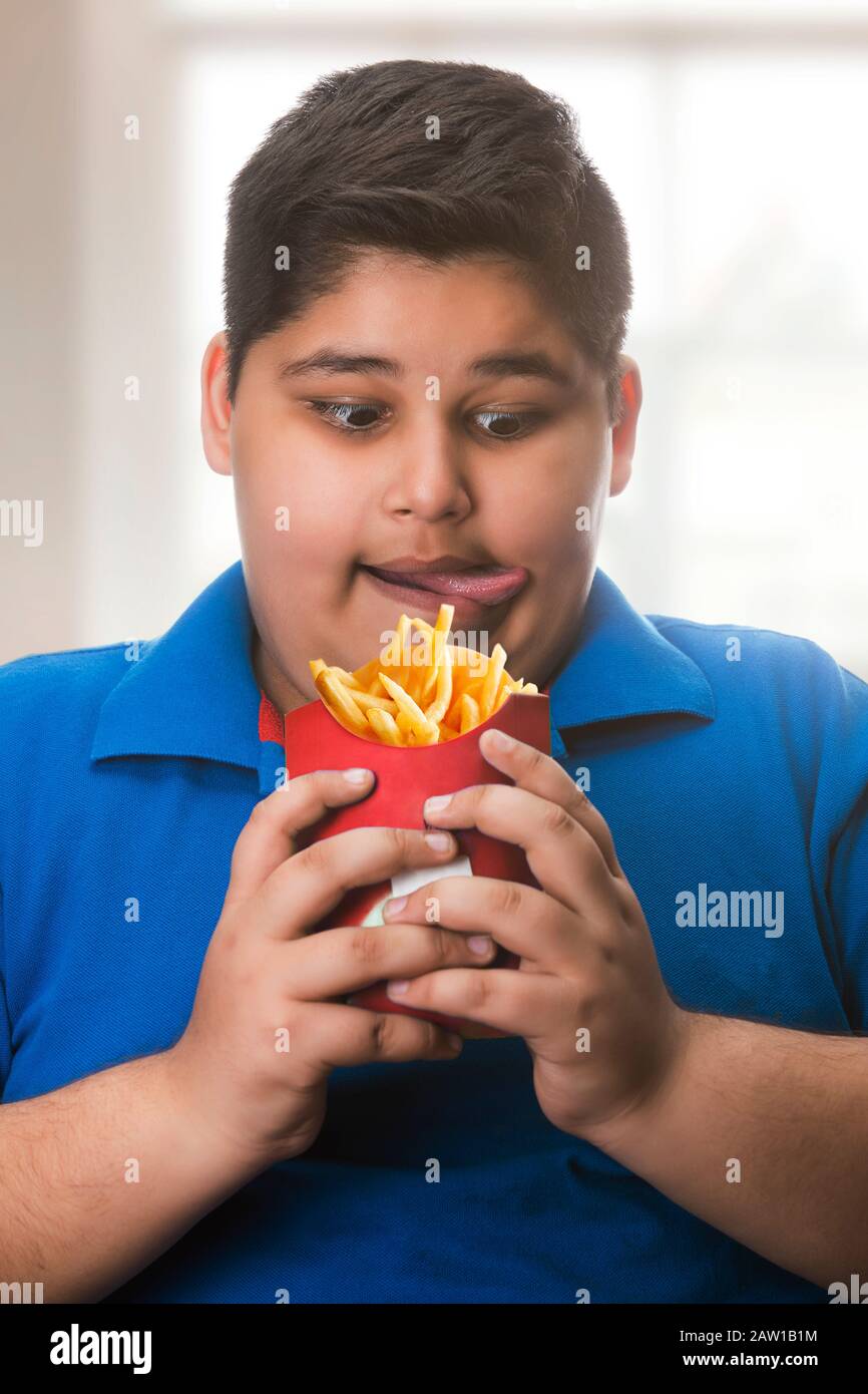 Chubby boy looking junk food hi-res stock photography and images - Alamy
