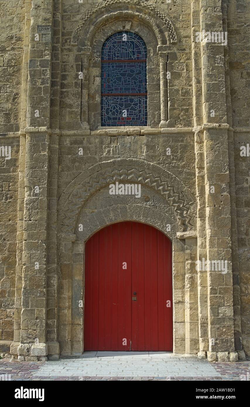View on red gate and window at gothic style catholic church entrance ...