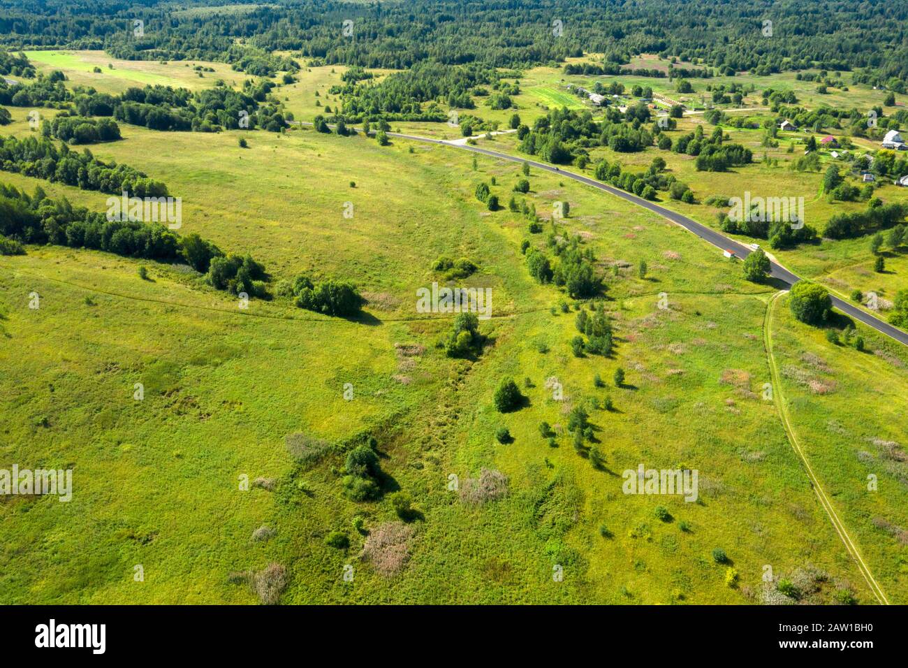 Aerial view from above of a field and a hilltop forest Stock Photo - Alamy