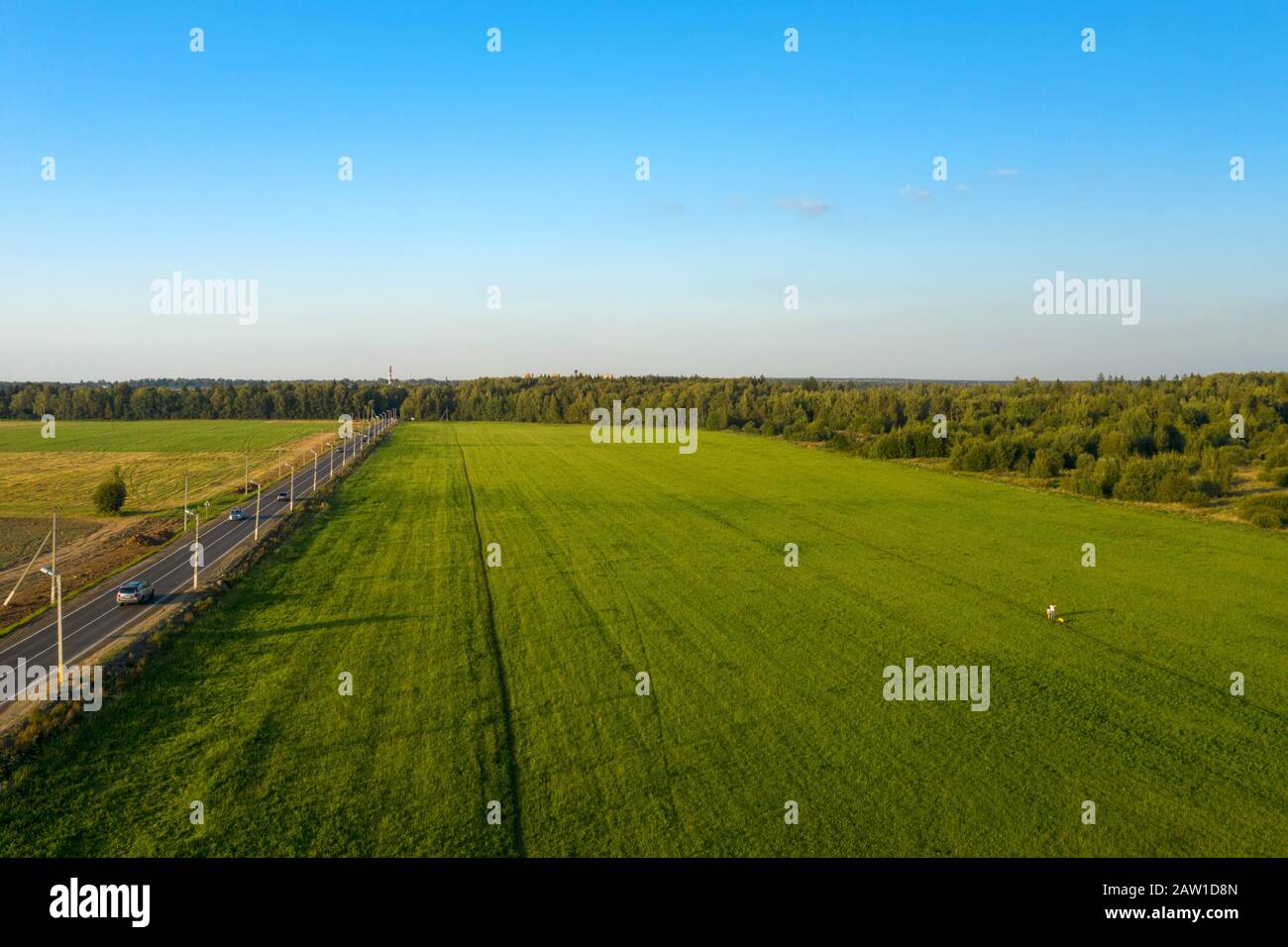 Aerial view of the road through the agricultural field Stock Photo - Alamy
