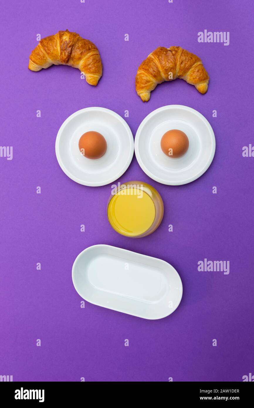 Fun breakfast concept with abstract astonished human face made of ...