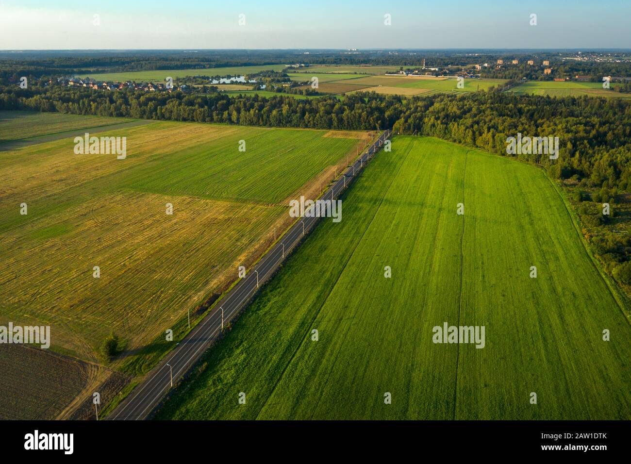 Aerial view of the road through the agricultural field Stock Photo - Alamy