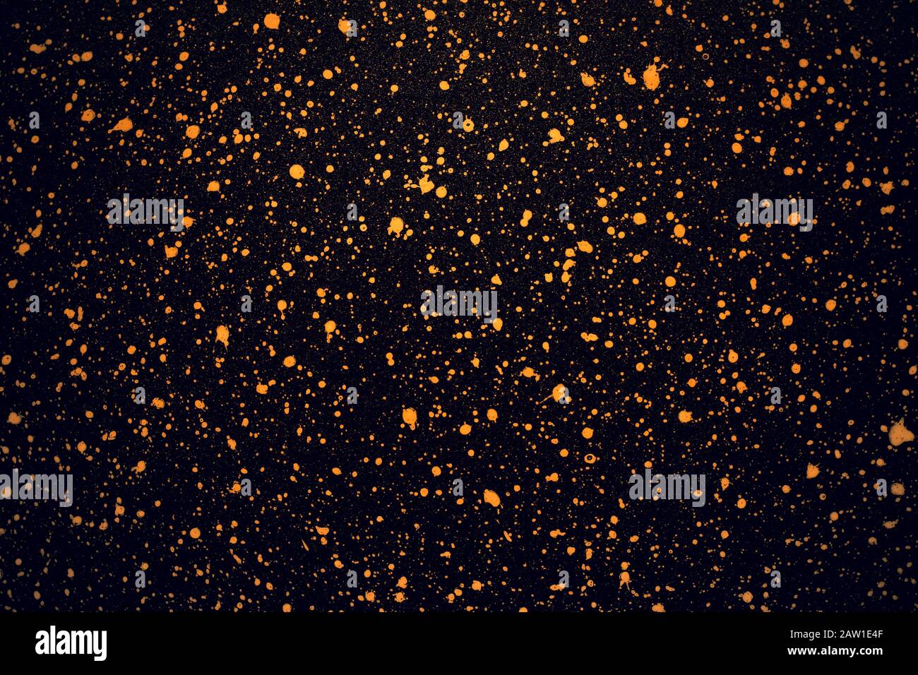 Yellow droplets of paint on black background. Abstract dark wallpaper ...