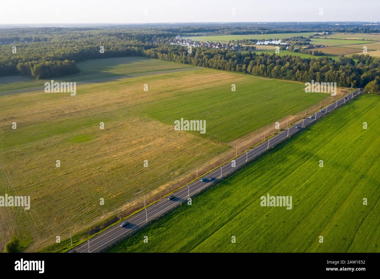 Aerial view of the road through the agricultural field Stock Photo - Alamy