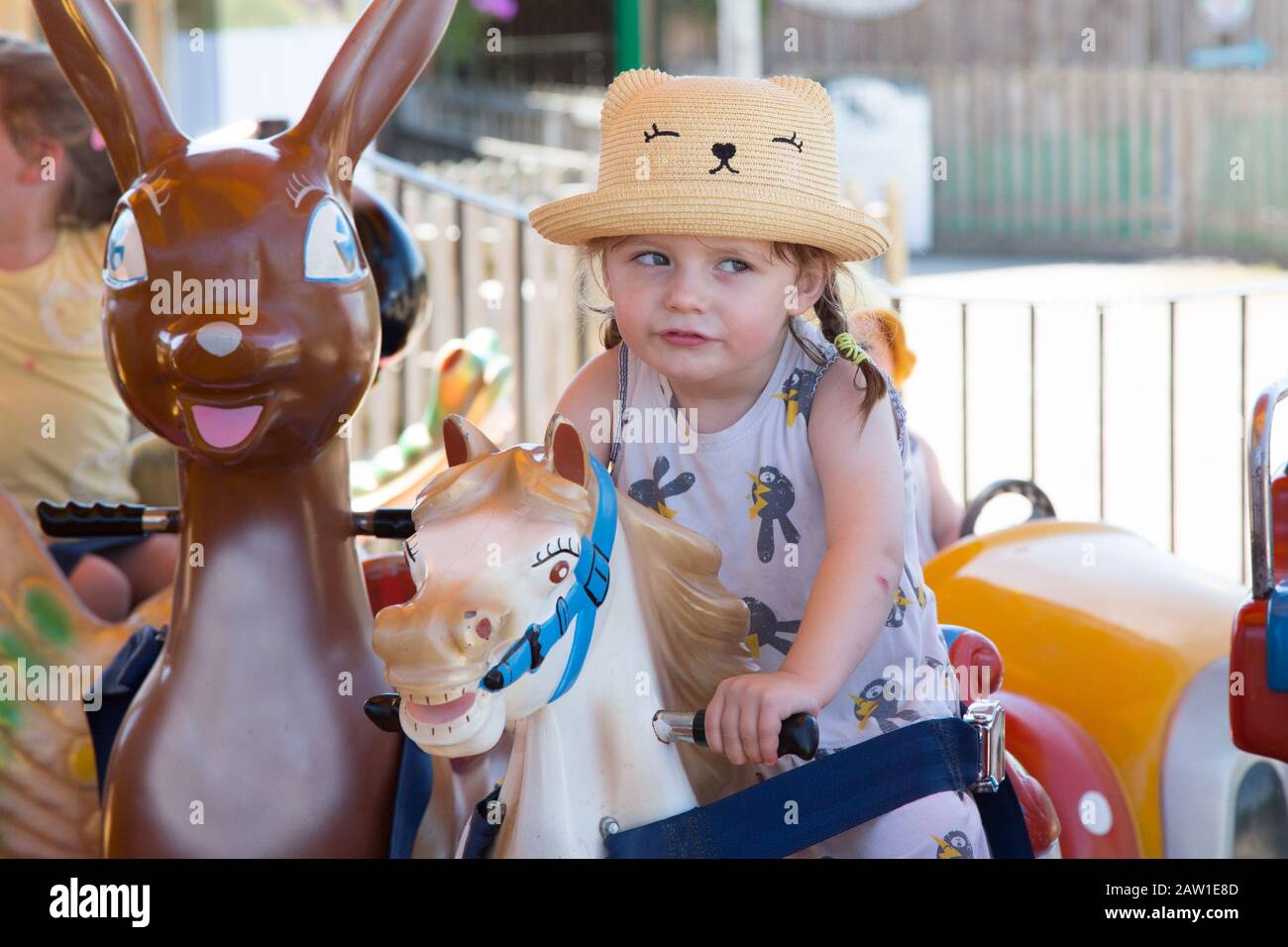 Children on a Merry go Round ride at a funfair, UK Stock Photo - Alamy