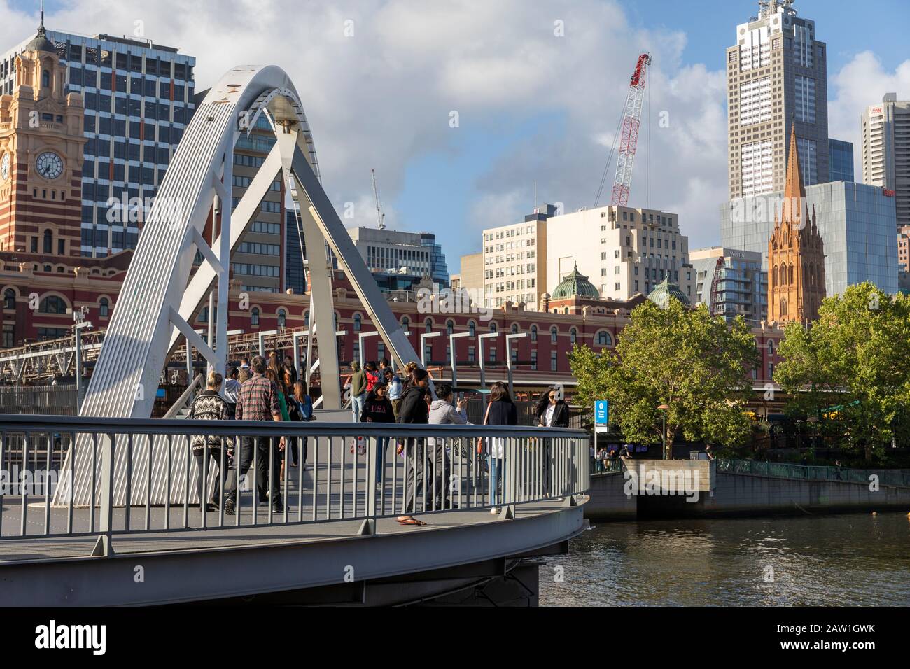 Melbourne, pedestrians cross the yarra river on the evan walker ...