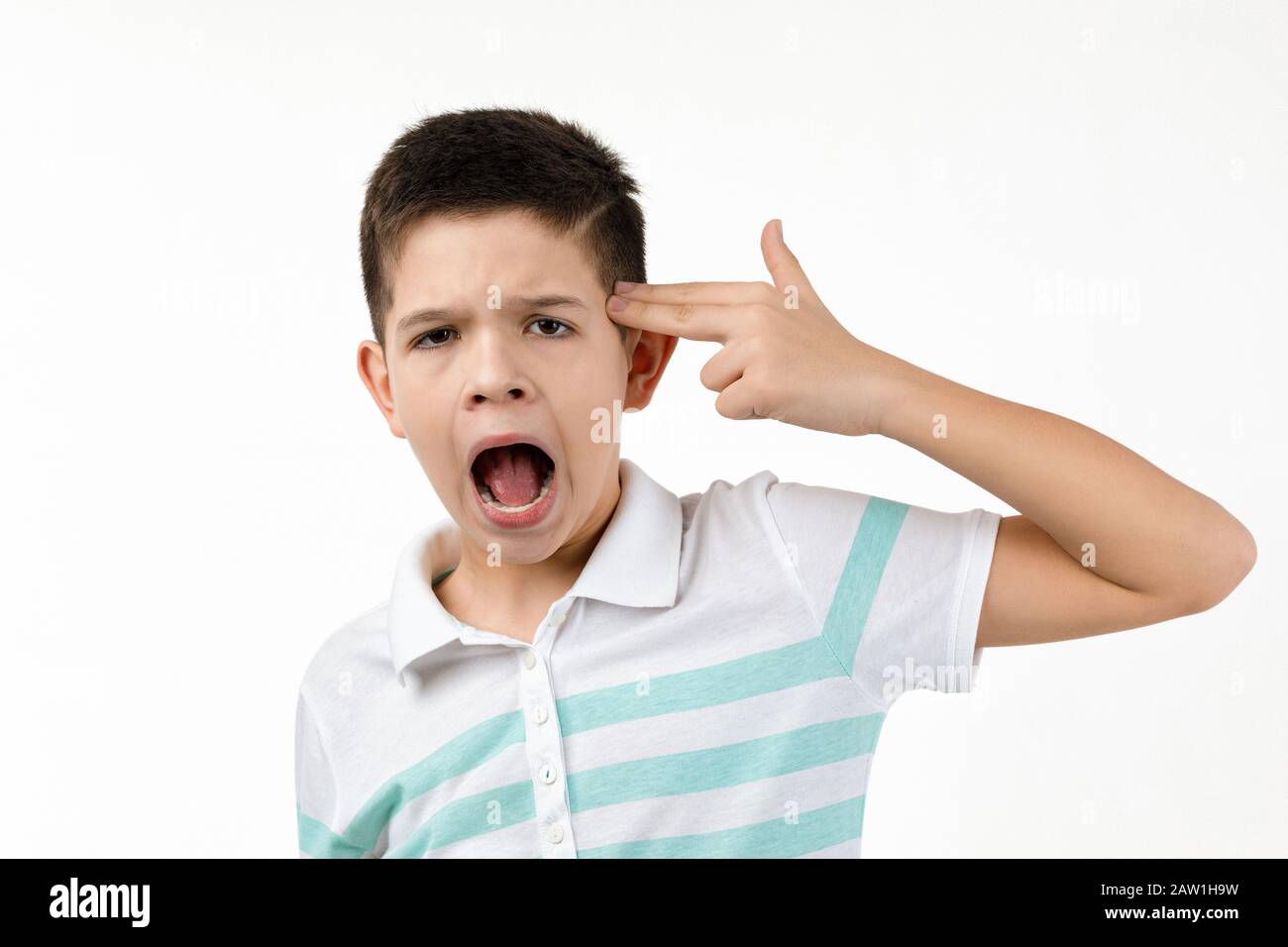 little boy in t-shirt shooting in temple with hand on white background ...