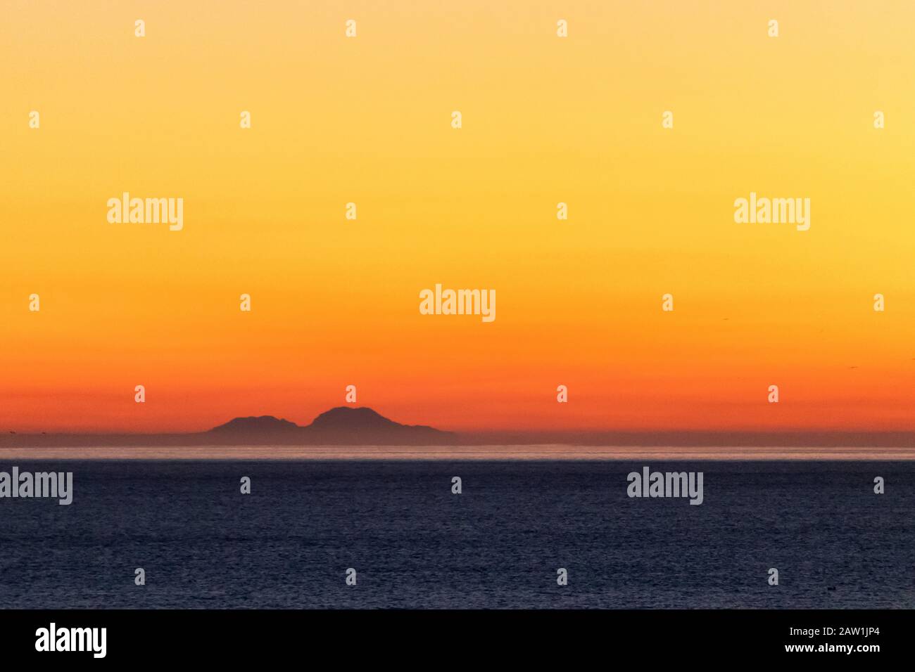 Sunset over Gibraltar surrounded by fog seen from Andalusia in Spain ...