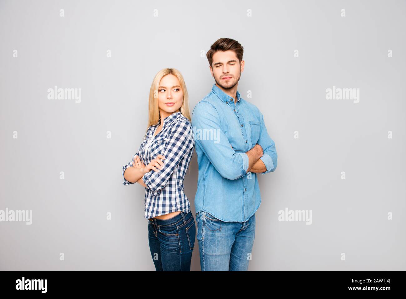 Young angry couple in love standing back to back Stock Photo - Alamy