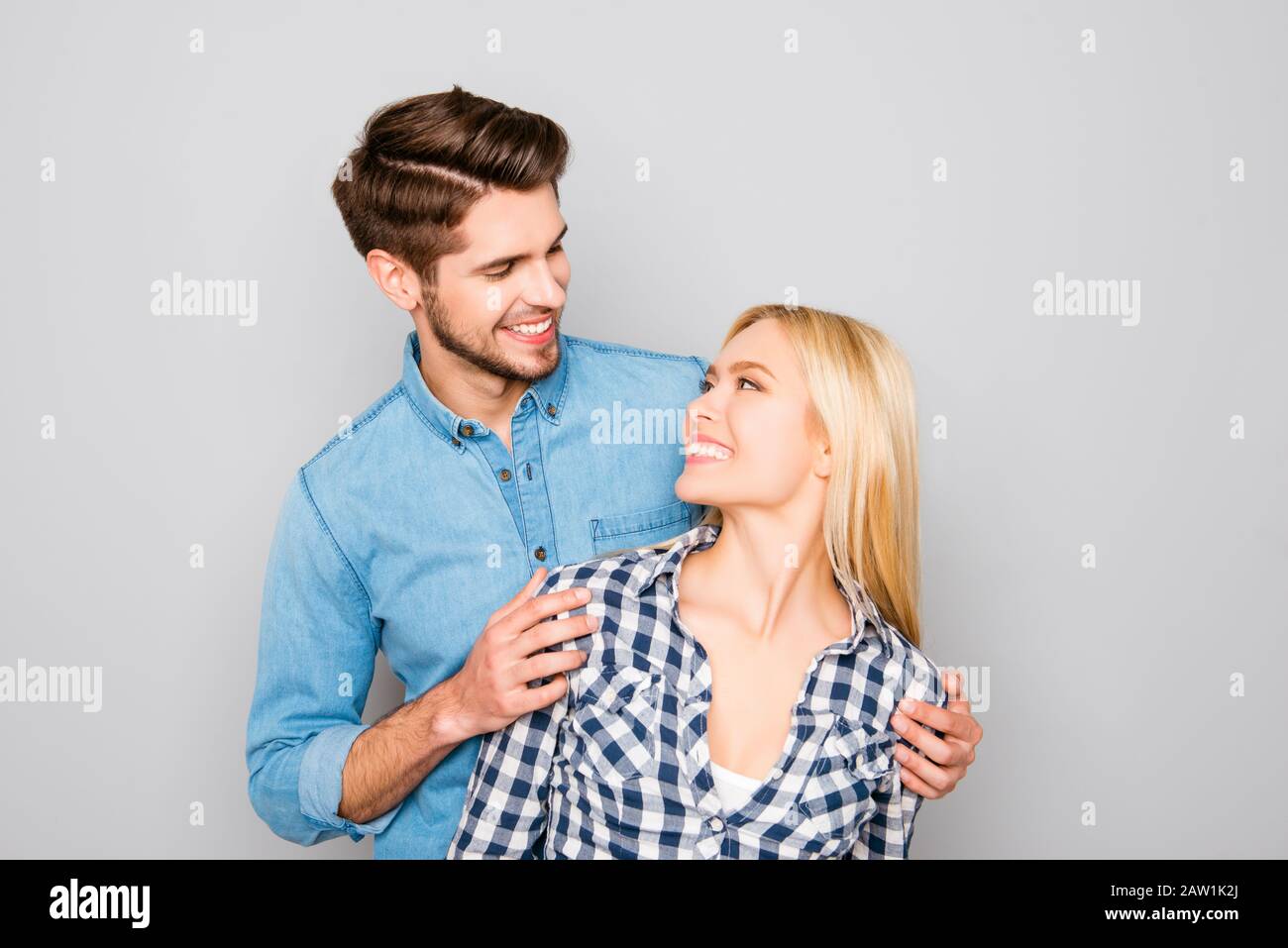Handsome young guy looking at his his smiling girlfriend Stock Photo ...