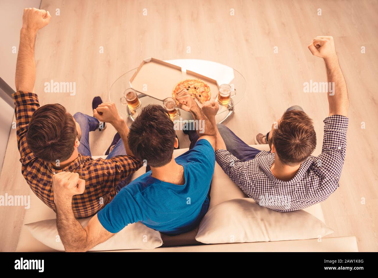 top-view photo of happy cheerful men resting and watching tv Stock ...