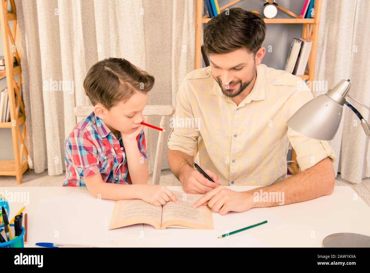 Young careful father teaching his little son Stock Photo - Alamy