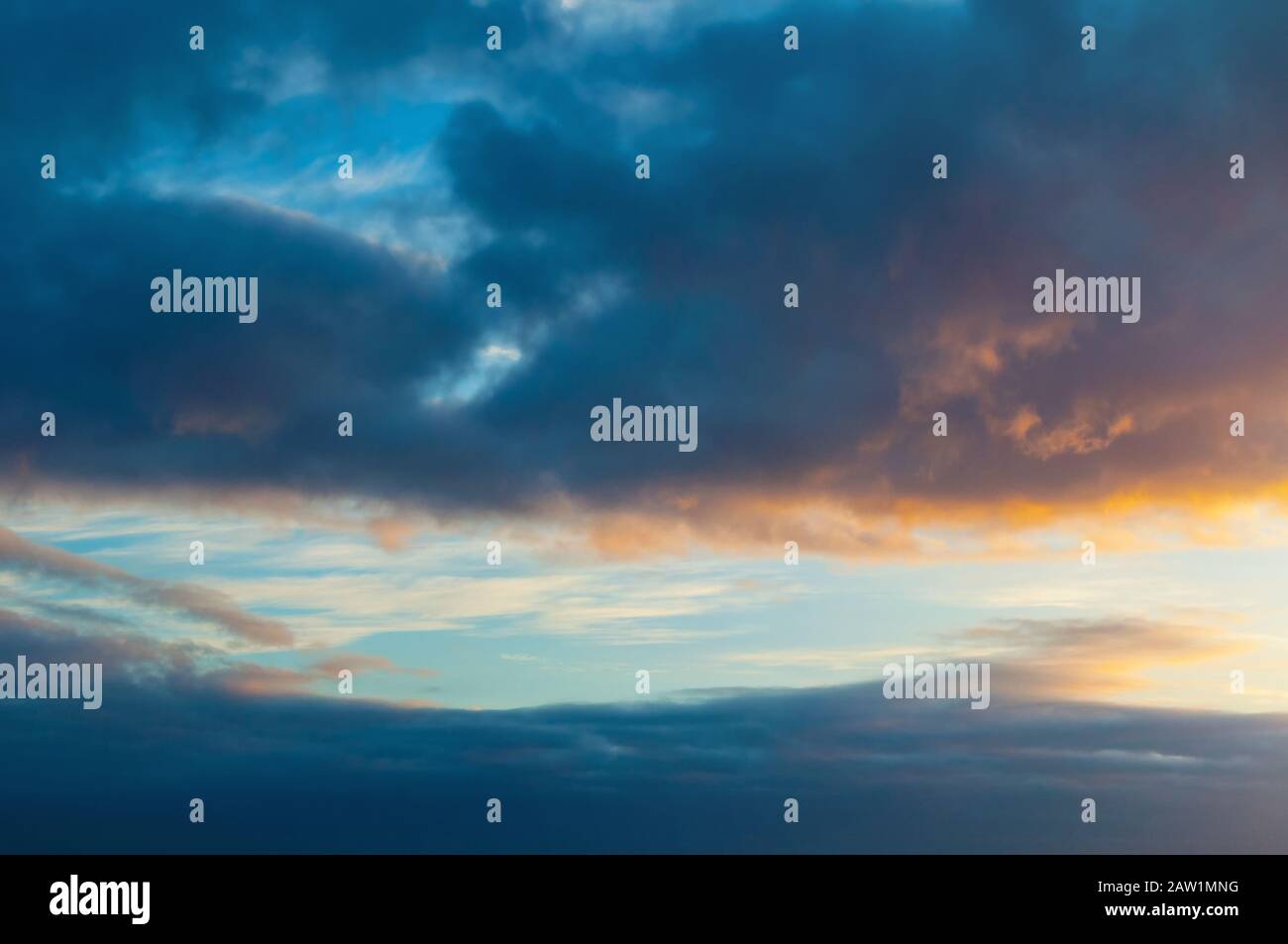 Dramatic blue sky background. Picturesque colorful clouds lit by ...