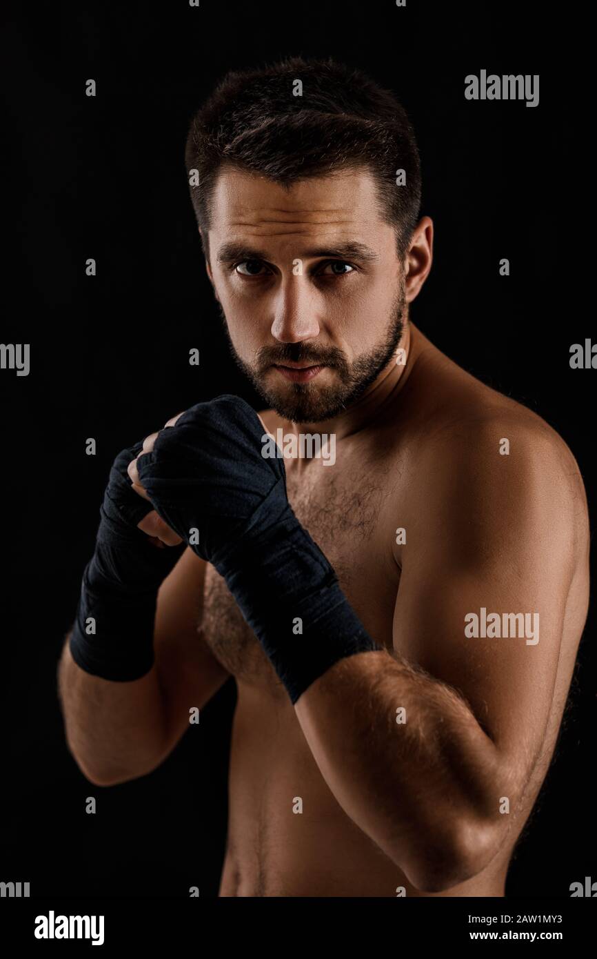 Muscular boxing man ready to fight on black background Stock Photo - Alamy
